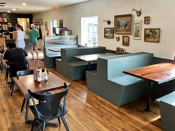 Inside, rustic charm meets serious barbecue business. Those vintage paintings and mounted deer heads silently whisper, "You've made the right choice."