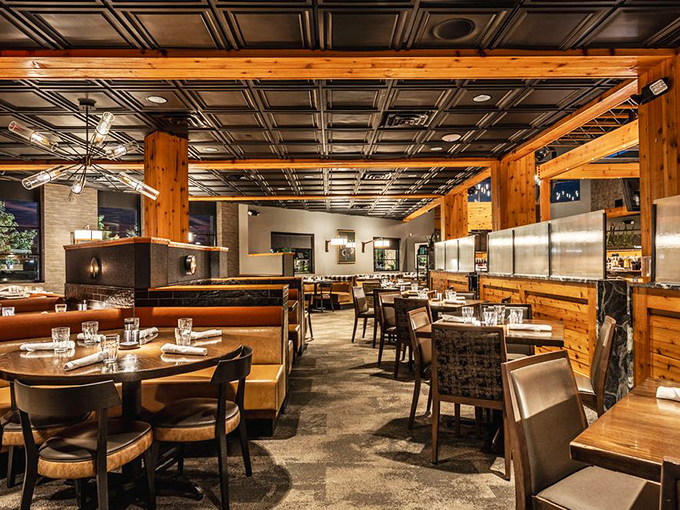 The dining room strikes that perfect balance between "fancy enough for your anniversary" and "comfortable enough to wear jeans." Those wooden beams aren't just supporting the ceiling—they're supporting your mood.