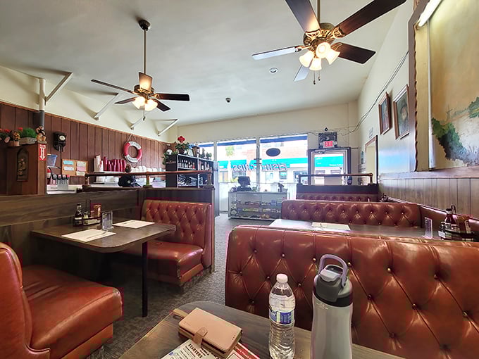Red vinyl booths and wood-paneled walls create a time capsule of coastal dining. No designer needed when the food does the talking.