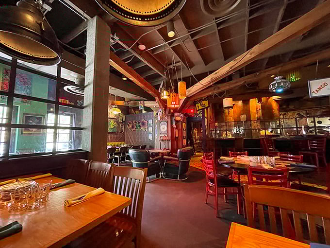 Inside, the restaurant transforms into an artistic wonderland where exposed beams, eclectic lighting, and mismatched furniture create the perfect bohemian dining atmosphere.