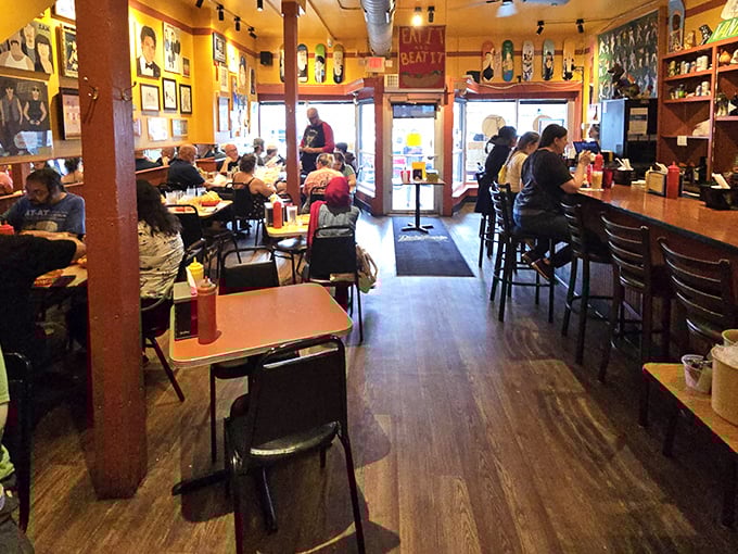Step inside and you're greeted by warm wood tones, vibrant yellow walls, and the unmistakable buzz of hot dog happiness in progress.
