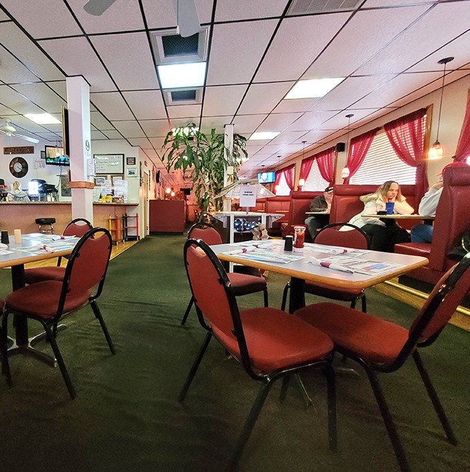 Red vinyl booths and checkered curtains aren't trying to be retro-chic—they're authentically timeless, like comfort food itself. The diner equivalent of a warm hug.