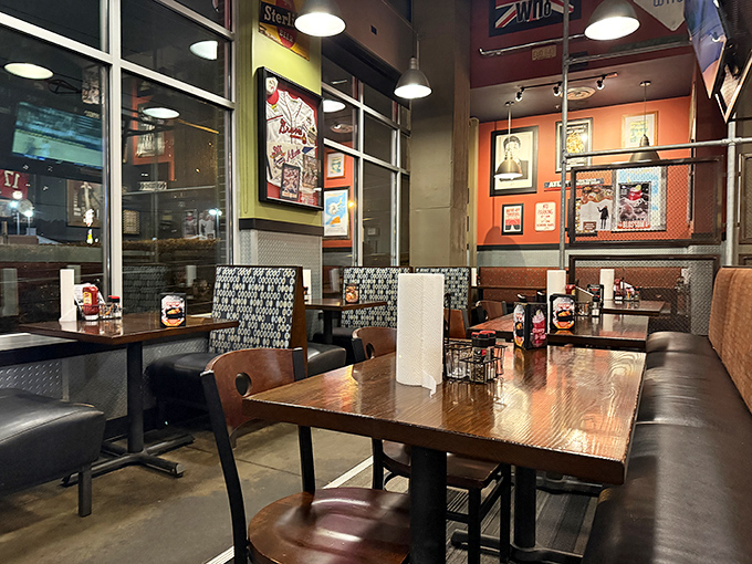 Sports memorabilia meets industrial-chic design inside, where wooden tables and cozy booths create the perfect backdrop for serious burger contemplation.
