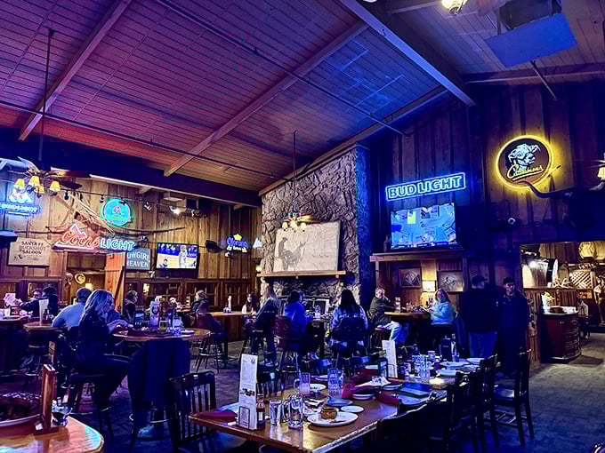 Step inside and you're transported to a Western wonderland where neon beer signs illuminate wood-paneled walls and stone fireplaces. This isn't trendy ambiance—it's authentic steakhouse atmosphere earned over decades.