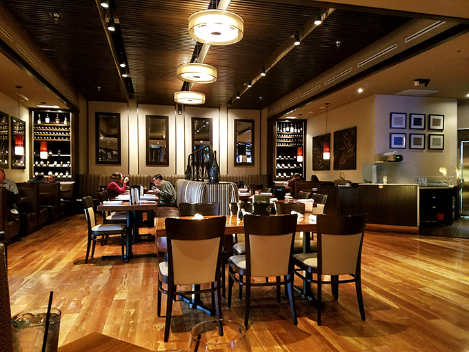 Step inside to discover warm wood floors, elegant lighting, and wine displays that whisper, "Stay awhile, the prime rib is worth it."