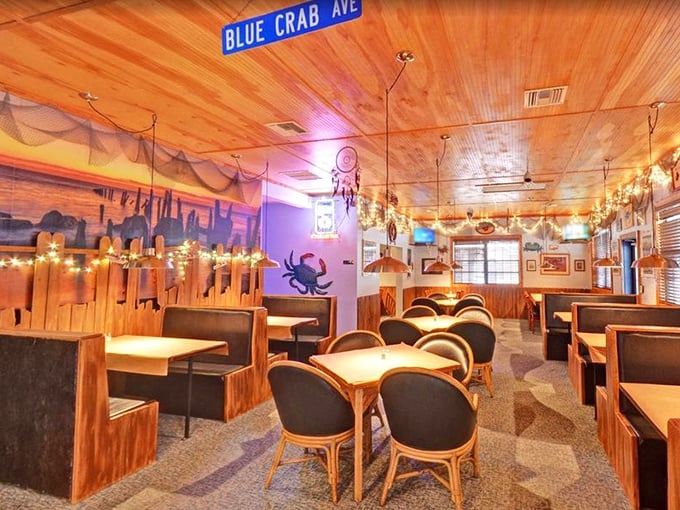 Inside, wooden warmth meets nautical whimsy with the "Blue Crab Ave" sign overhead—like a beach house that happens to serve incredible food.