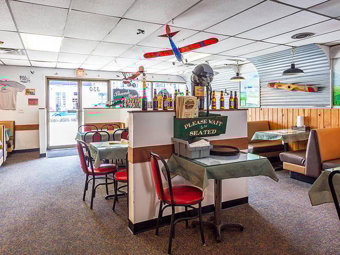 Model airplanes dangle from the ceiling while red chairs invite you to sit and stay awhile. Nostalgia served alongside burgers.