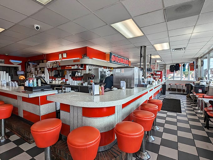 Step inside and time travels backwards—orange counter stools and checkerboard floors whispering stories of decades past. This isn't retro by design; it's retro by survival.