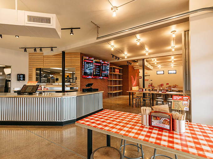 Industrial-chic meets down-home comfort in this thoughtfully designed space. The checkered tablecloths promise no pretension—just serious chicken business ahead.