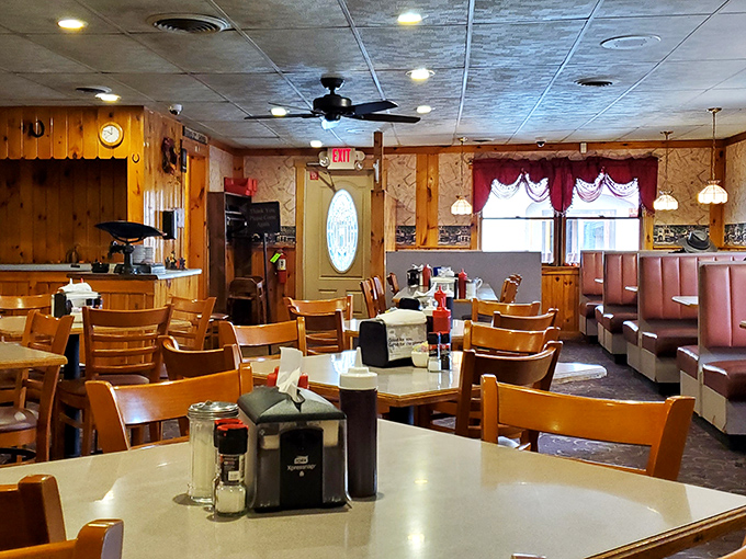 Wood paneling, pink booths, and ceiling fans spinning stories overhead—this isn't retro by design, it's authentic by default.
