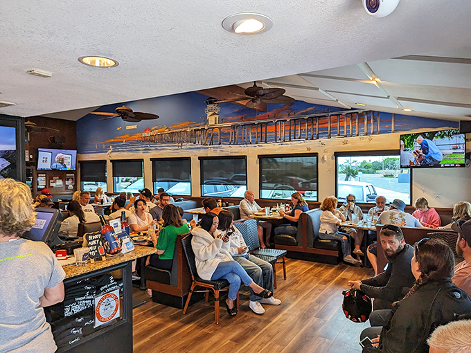 Inside, the bustling dining room hums with conversation while a beautiful mural of Newport Pier stretches across the wall – a love letter to the coastal community it serves.