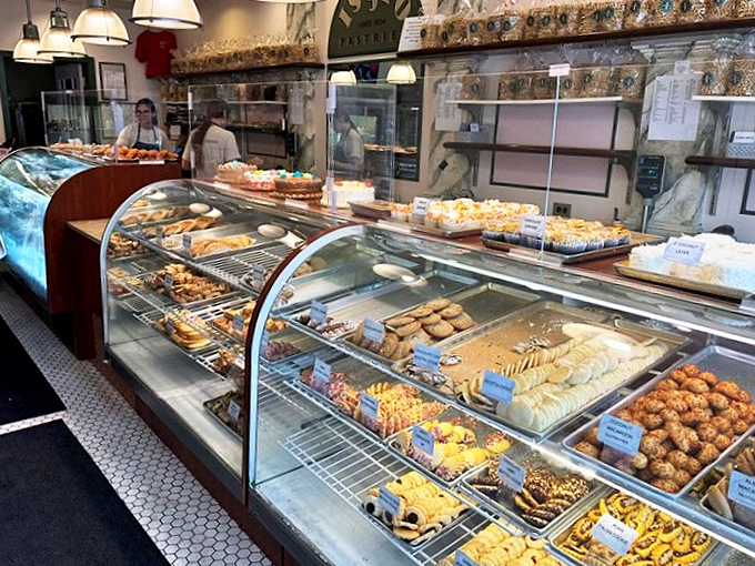 Treasure chests of Italian delights await behind curved glass. This isn't just a display case—it's a museum where the exhibits are deliciously ephemeral.