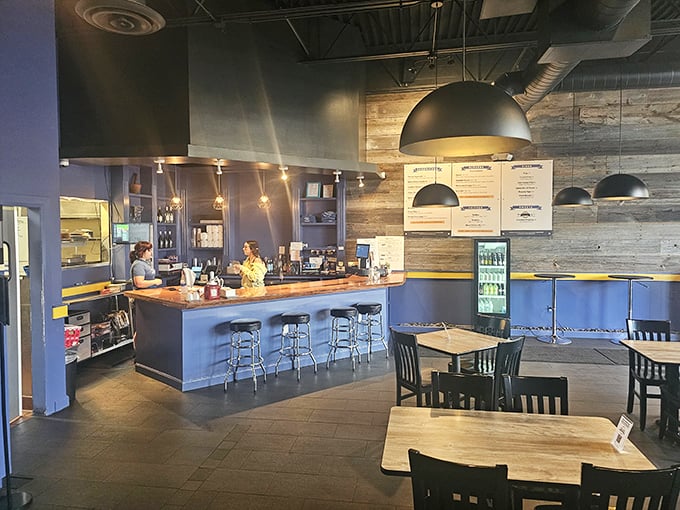 Industrial-chic meets burger paradise with reclaimed wood walls and pendant lighting. The minimalist interior lets you focus on what matters—the impending food euphoria.