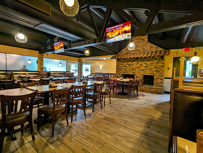 Rustic wooden beams meet stone accents in this dining room that somehow manages to feel both spacious and cozy—like your favorite sweater got turned into a restaurant. 
