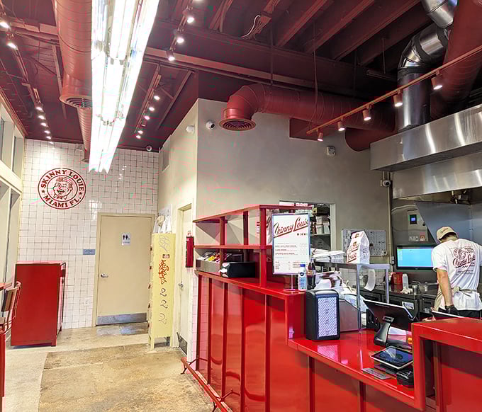 Industrial-chic meets burger paradise with those signature red pipes overhead—proof that great design and greater food can coexist beautifully.