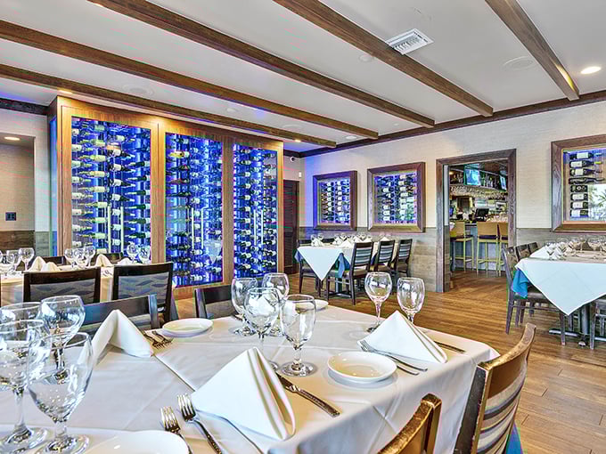 Elegant dining meets coastal comfort with Billy's impressive wine display. The warm wood beams overhead create the perfect atmosphere for seafood indulgence.