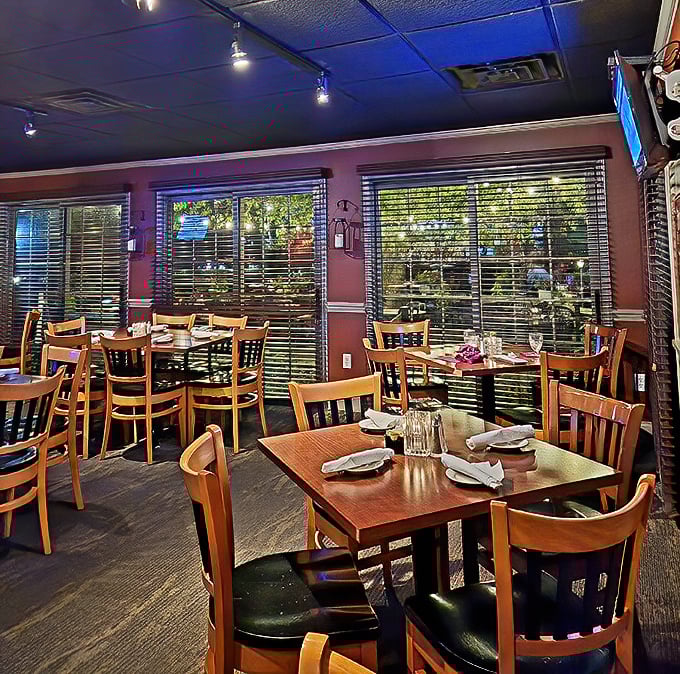 Warm wooden tables and burgundy walls create the perfect backdrop for memorable meals. This isn't just dining—it's a cozy retreat from the outside world.