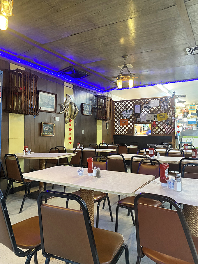 Blue lights and wood paneling create that "you're not in Kansas anymore" vibe—a dining room that feels like you've stepped into a beloved captain's quarters.
