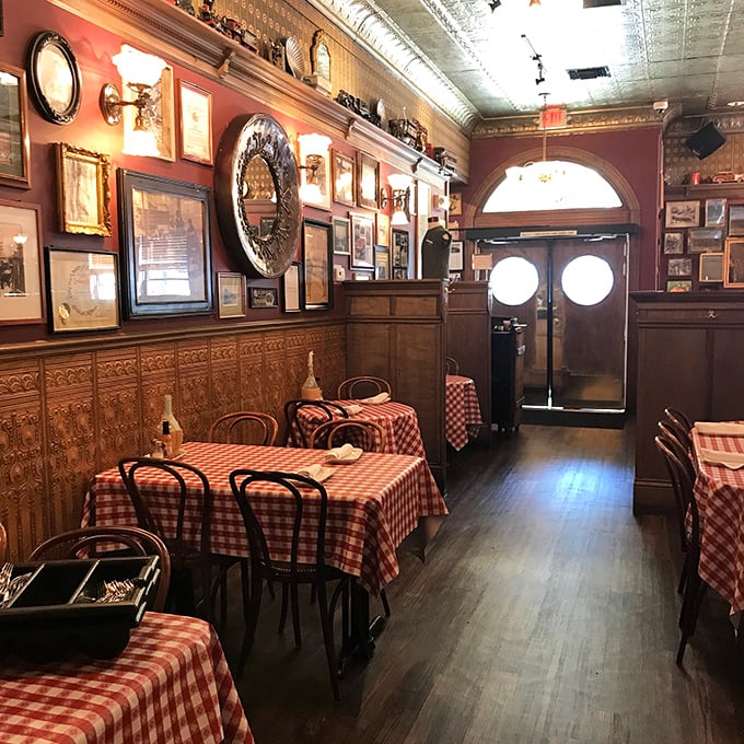 Step inside this maritime time capsule where red checkered tablecloths meet nautical nostalgia perfectly.