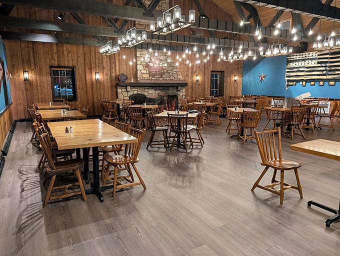 Wooden beams, warm lighting, and that statement stone fireplace create the perfect backdrop for the serious business of barbecue appreciation.