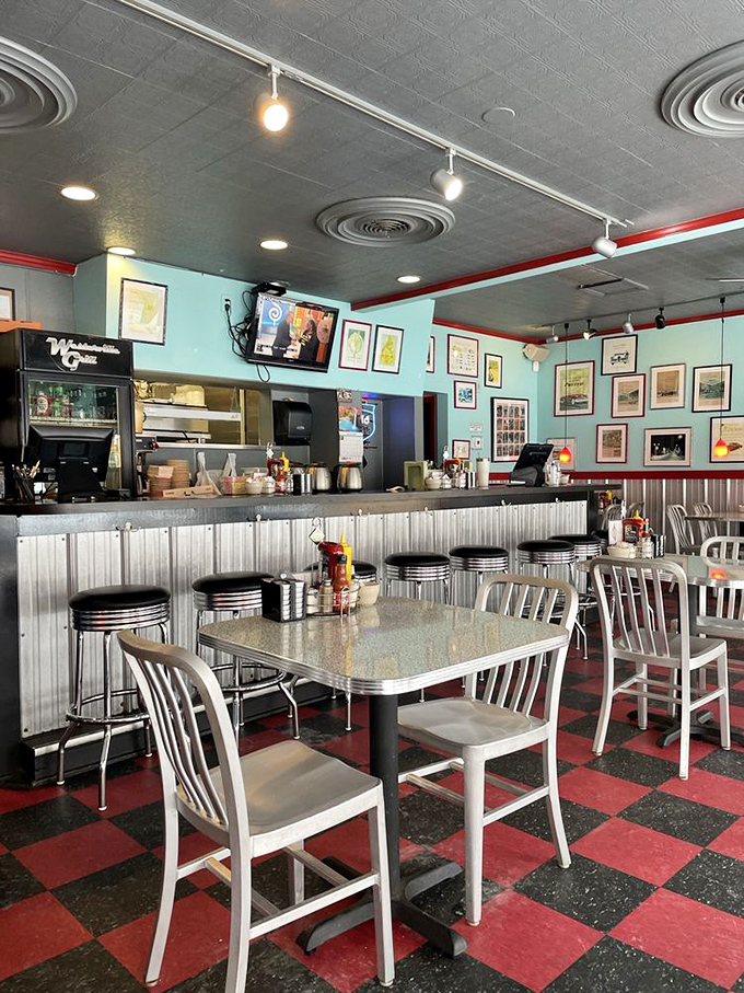 Inside, the red and black checkerboard floor sets the stage for diner magic, where every chrome-edged table holds the promise of satisfaction.