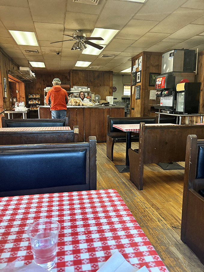 Classic diner vibes with wood paneling and checkered tablecloths – like stepping into a time machine where smartphones don't exist but perfect sandwiches do. 