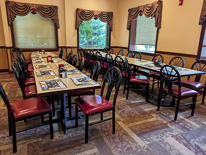 Red chairs and warm wood tones create that perfect "grandma's dining room" vibe, minus the plastic-covered furniture.