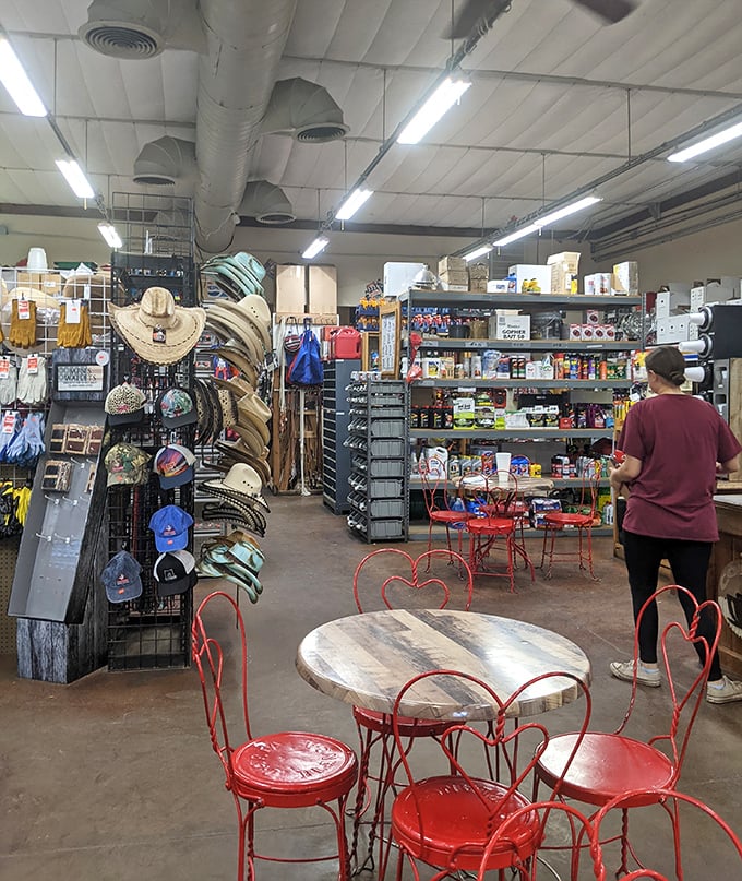 Inside, time slows down as you navigate a wonderland of cowboy hats, snacks, and those charming red chairs beckoning you to sit a spell.