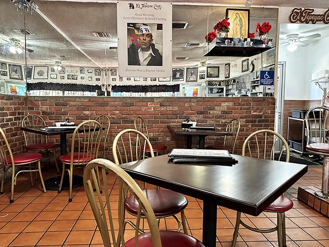 Red vinyl seats and brick walls tell stories of decades past, while framed memories line the walls—this isn't Instagram-designed decor, it's the real deal.