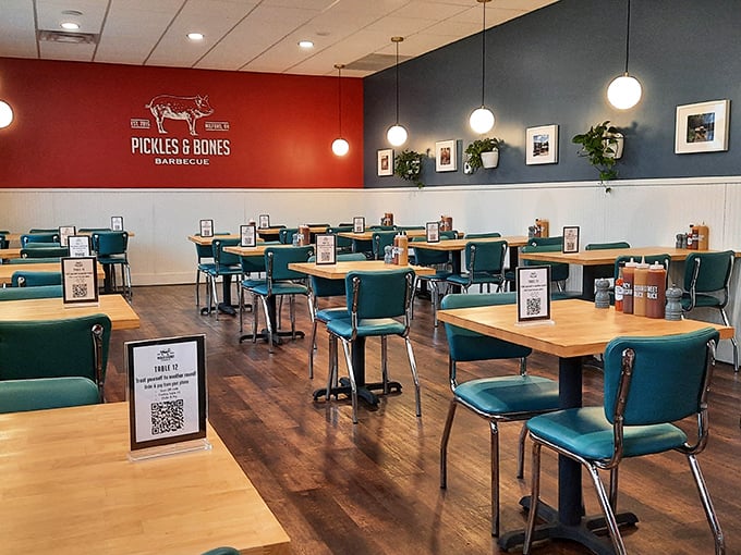Teal chairs against red and blue walls create a modern diner vibe that says, "We're serious about barbecue, but not too serious about ourselves."
