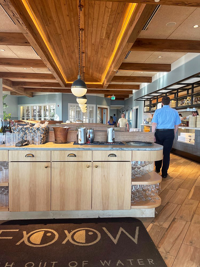 Wood beams and ocean hues create a space that whispers sophistication without shouting about it.