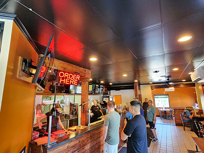 Where barbecue dreams begin. The glowing "ORDER HERE" sign might as well say "Happiness This Way" for meat lovers on a pilgrimage.