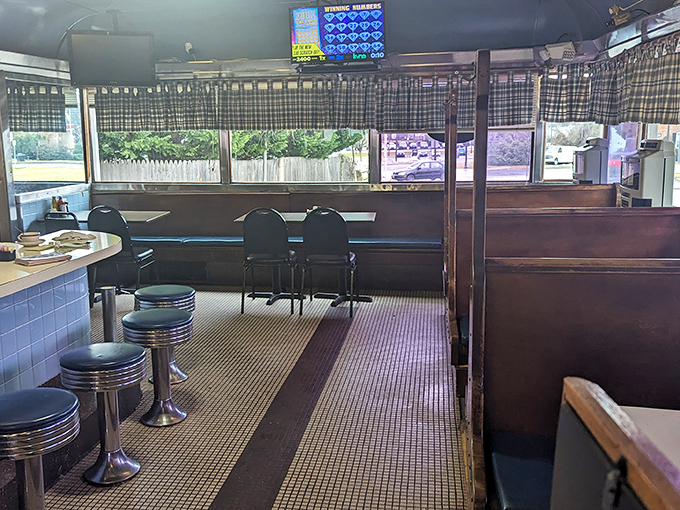 Chrome stools await their next storytellers while checkered curtains filter the morning light—this isn't décor, it's diner DNA in its purest form.