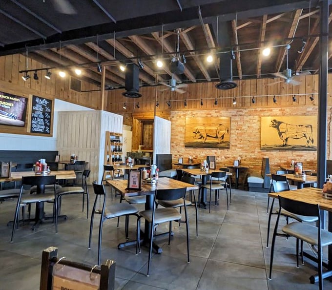 Rustic meets refined inside with exposed beams, brick walls, and whimsical pig artwork—a temple where barbecue is taken seriously without taking itself too seriously.