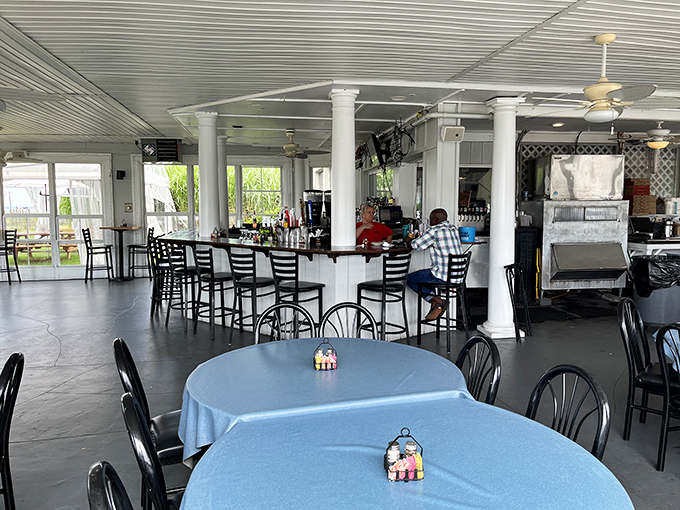 Inside, white columns and blue tablecloths create a nautical vibe that's sophisticated yet comfortable—like a beach house owned by your most successful friend.