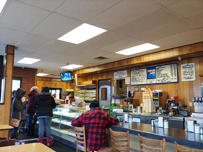 Morning pilgrims line up for their daily devotional. In the religion of donuts, patience is indeed a virtue.