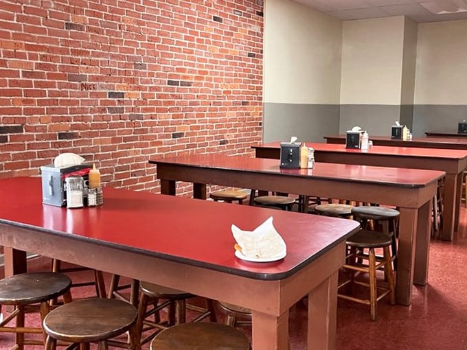 Those red tables have hosted more conversations than a therapist's couch – and they're way cheaper.
