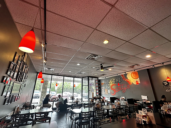 Red pendant lights cast a warm glow over the dining room. That "Welcome to Scotty's" mural isn't just decoration—it's a promise.