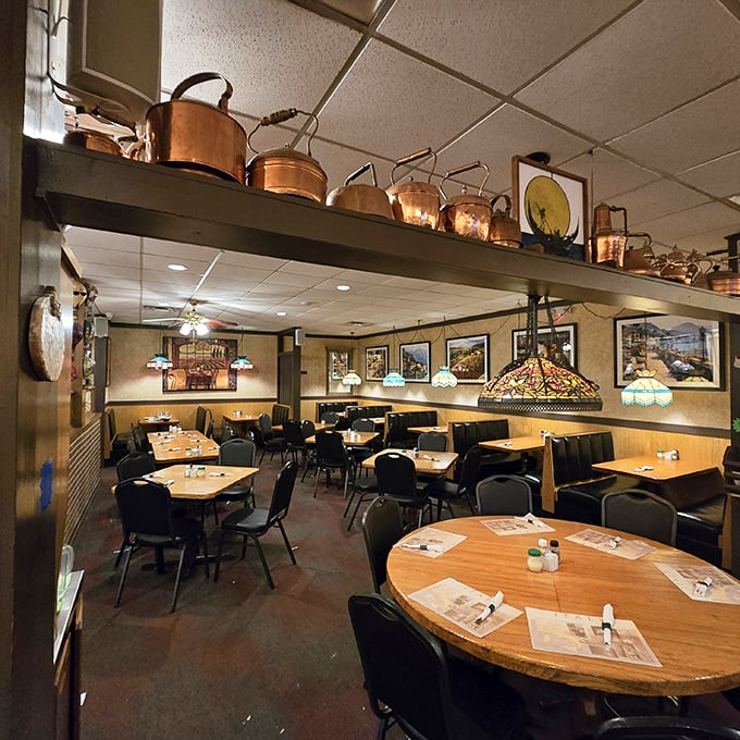 Copper pots gleam overhead like culinary constellations in Villa Nova's dining room. The warm glow of Tiffany lamps transforms simple tables into stages where pasta dreams come true.