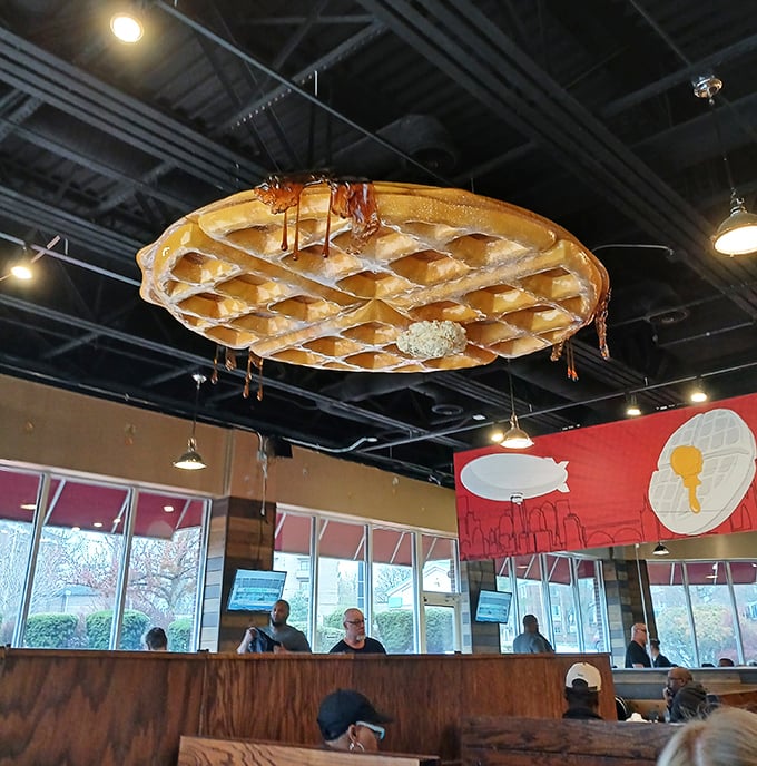 Look up! That giant waffle chandelier isn't just decoration—it's a preview of the golden, syrupy heaven awaiting your taste buds below.