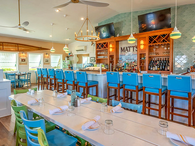 Blue chairs that match the ocean outside, warm wood tones, and a bar that beckons—this is where seafood dreams come true.