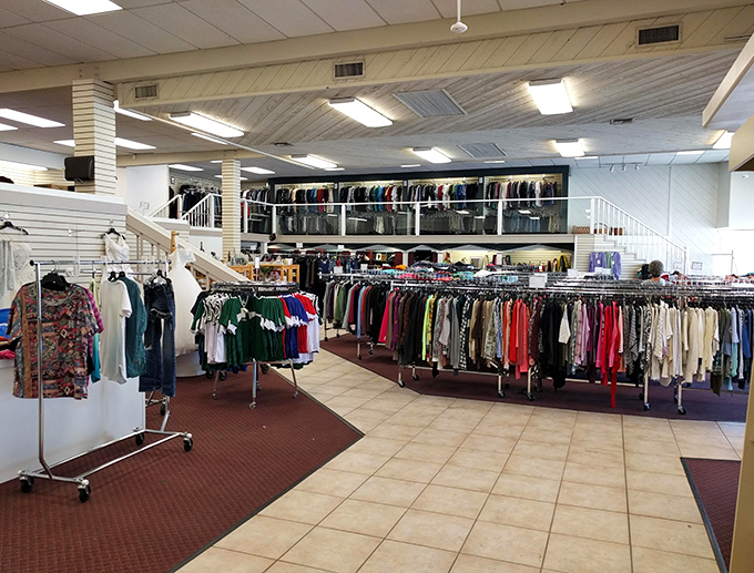 A sea of carefully organized clothing racks stretches across the main floor, with the mezzanine level promising even more sartorial adventures for the patient treasure hunter.