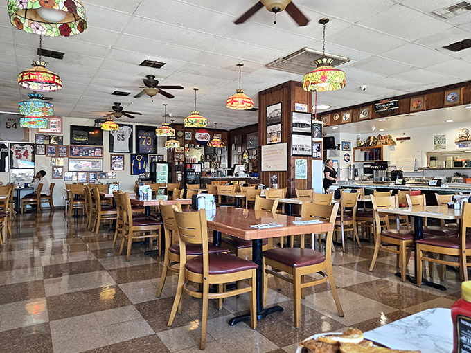 Tiffany-style lamps cast a warm glow over the checkered floor, while sports memorabilia tells stories of local legends and beloved teams.