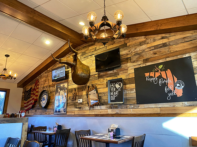 Rustic wooden walls adorned with Americana create the perfect backdrop for BBQ feasting. That longhorn isn't just decoration—it's keeping an eye on your leftovers.