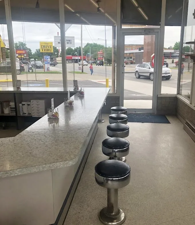 Classic counter seating where strangers become friends over shared sugar highs. These stools have witnessed more morning revelations than most therapists.