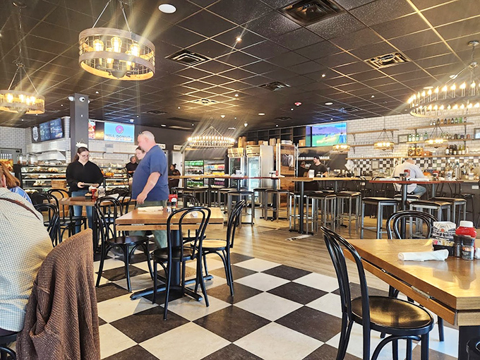 The classic black and white checkered floor isn't just nostalgic—it's a chessboard where every move leads to delicious victory. Modern lighting elevates the cozy diner vibe.