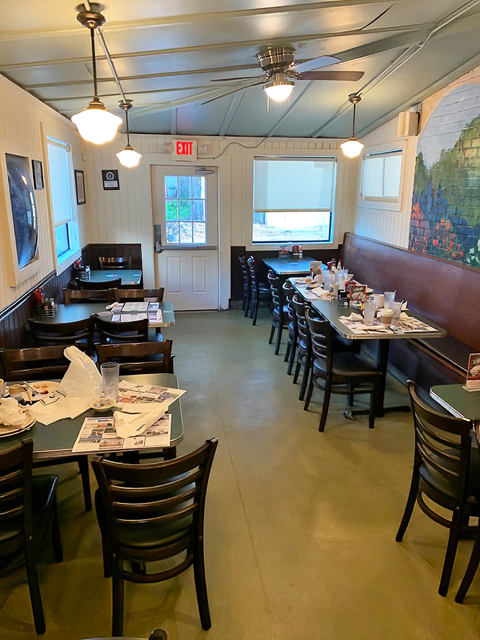 Classic diner charm with a Florida twist—pale blue ceiling, cozy booths, and newspapers waiting to be perused while debating between sweet or savory breakfast options.