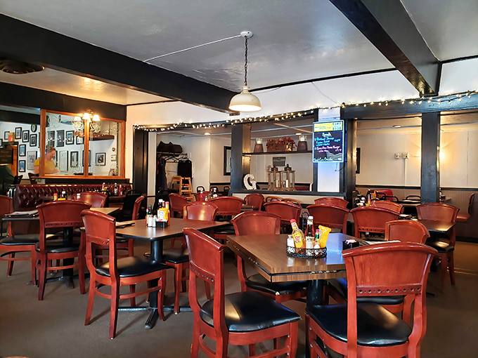 Red chairs, warm wood, and twinkling string lights create the perfect backdrop for serious steak contemplation. This isn't décor—it's dinner theater for carnivores.
