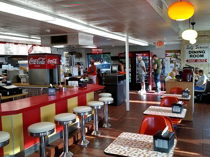 Step inside and you're transported to a simpler time—chrome counter stools, vintage Coca-Cola signs, and the promise of comfort food done right.