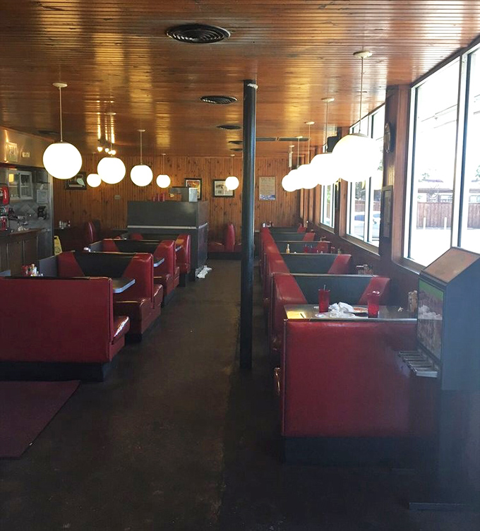 Red vinyl booths and wood-paneled walls tell stories of countless conversations, while globe lights cast that perfect "your food is about to arrive" glow.
